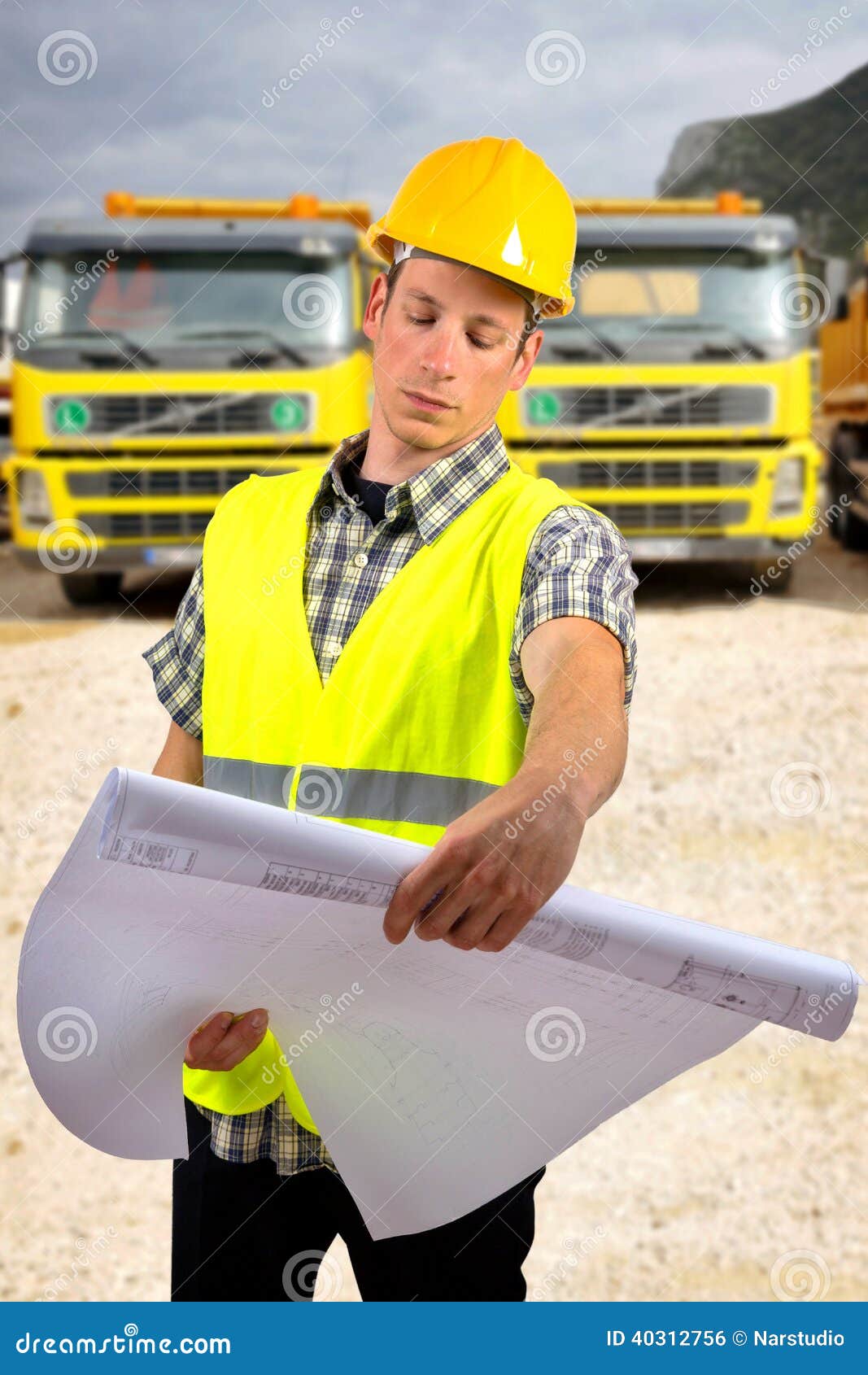 Construction Worker Holding Project Documents at Construction Site ...