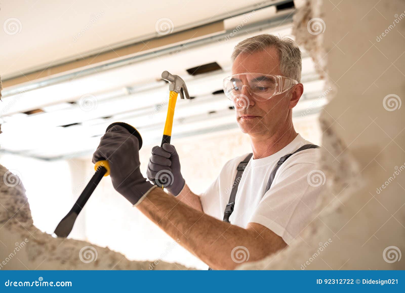 Construction Worker Holding Tool and Smash Drywall Stock Photo - Image ...