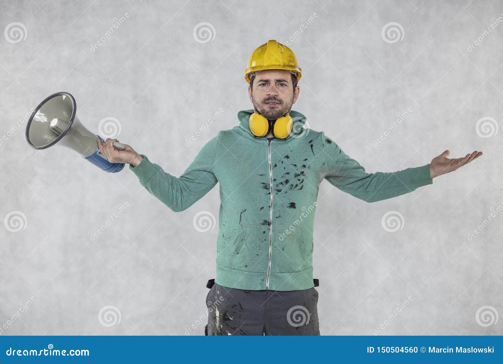 The Construction Worker Holds a Megaphone in His Hands, the Concept of ...