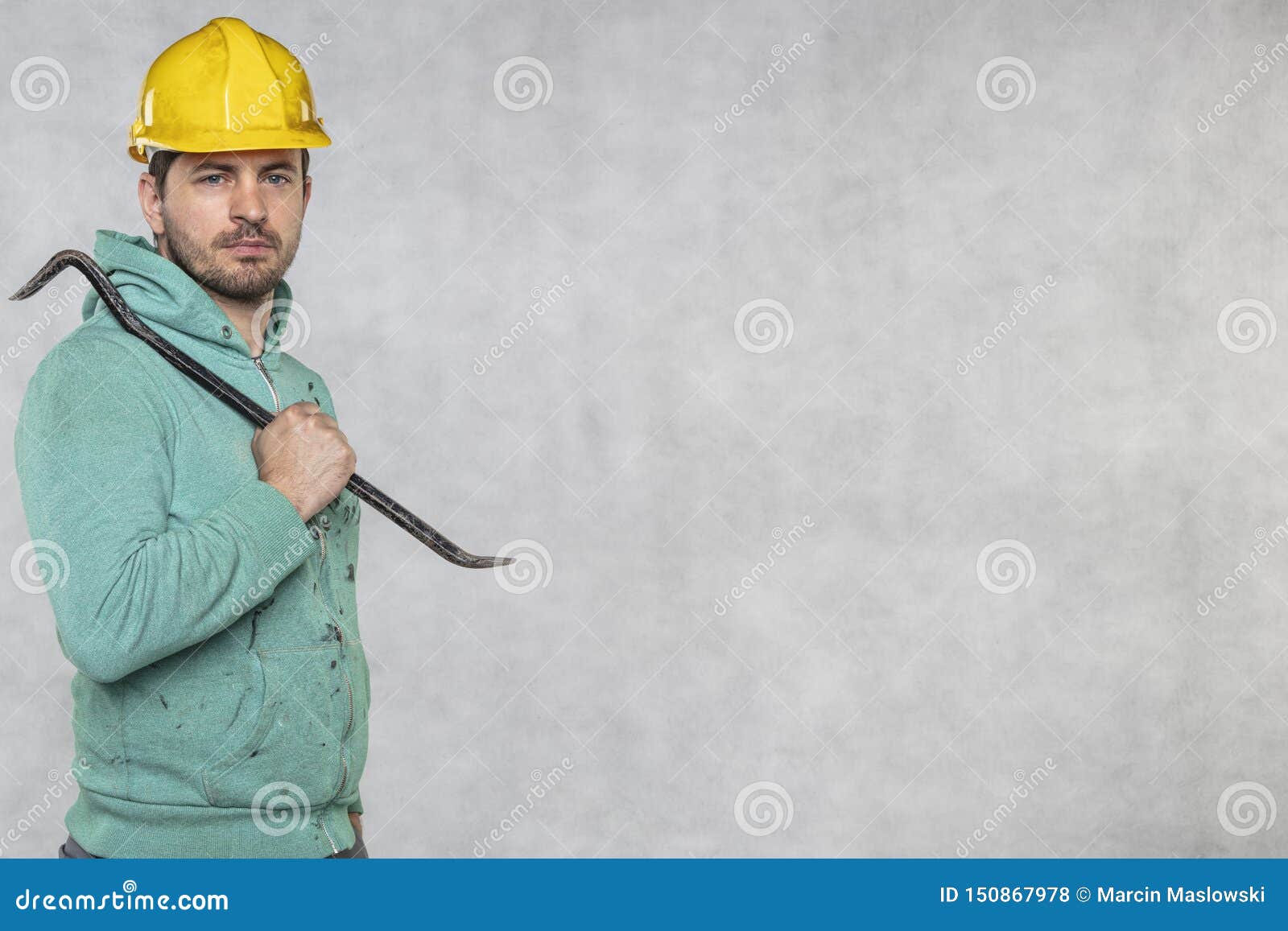 The Construction Worker Holds a Work Tool in His Hands, a Crowbar Stock ...