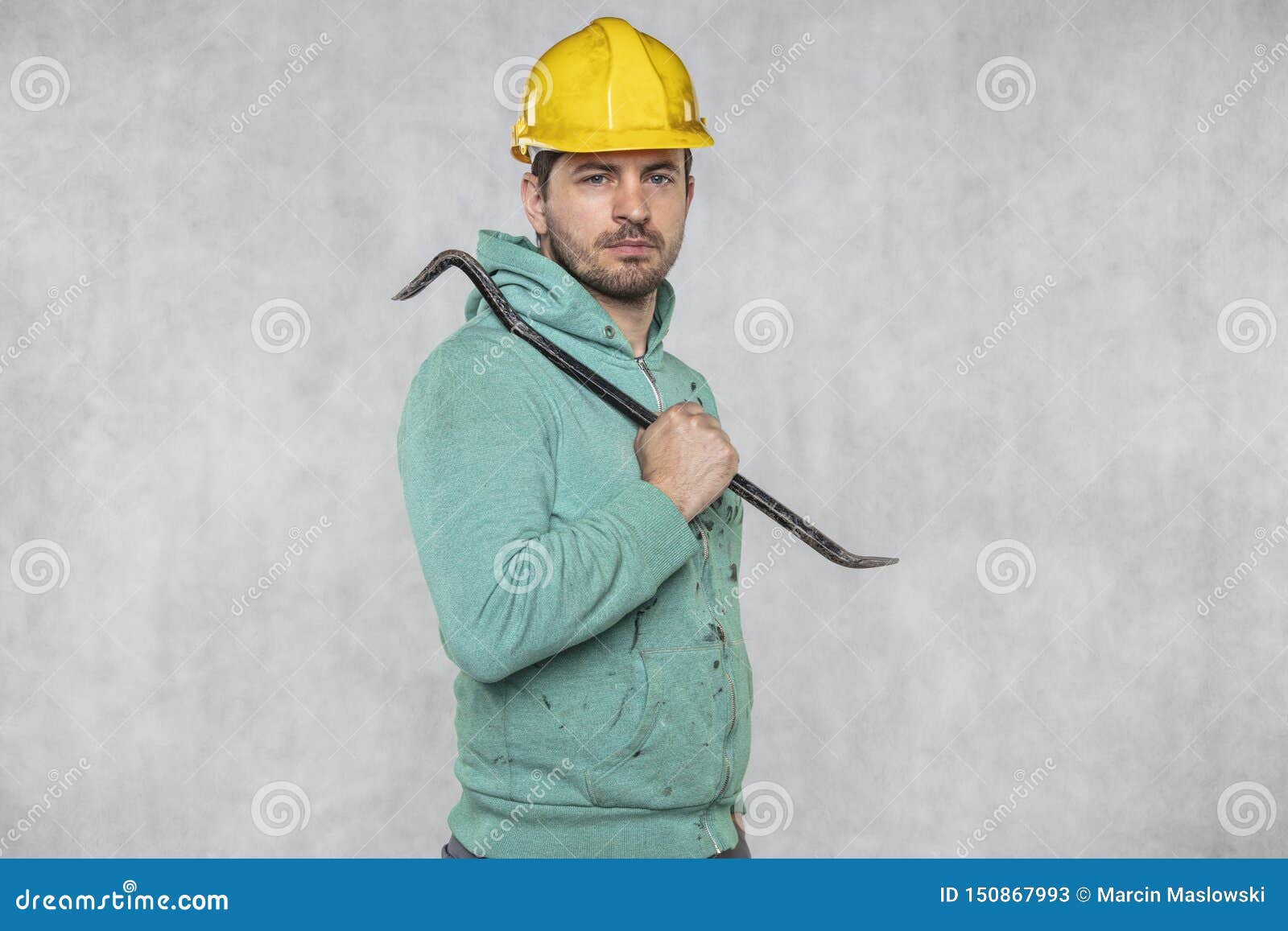 The Construction Worker Holds a Work Tool in His Hands, a Crowbar Stock ...