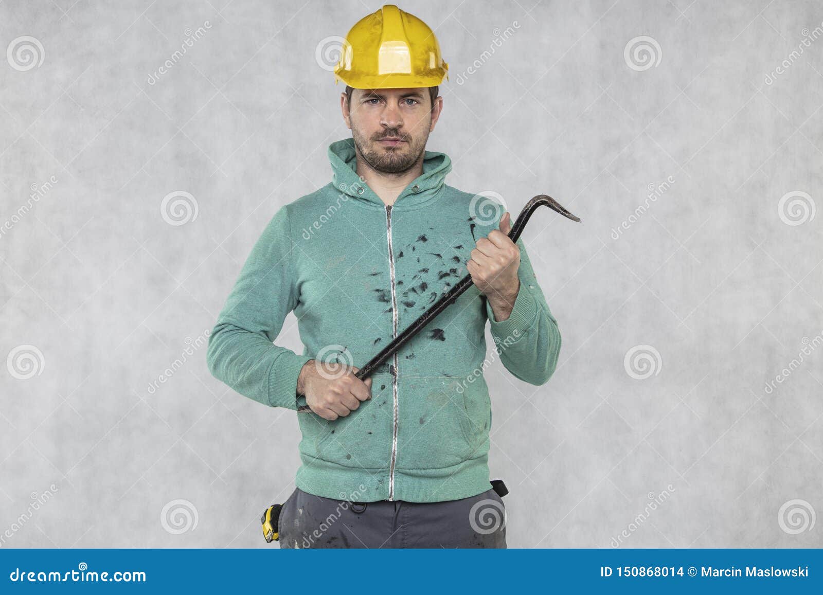 The Construction Worker Holds a Work Tool in His Hands, a Crowbar Stock ...