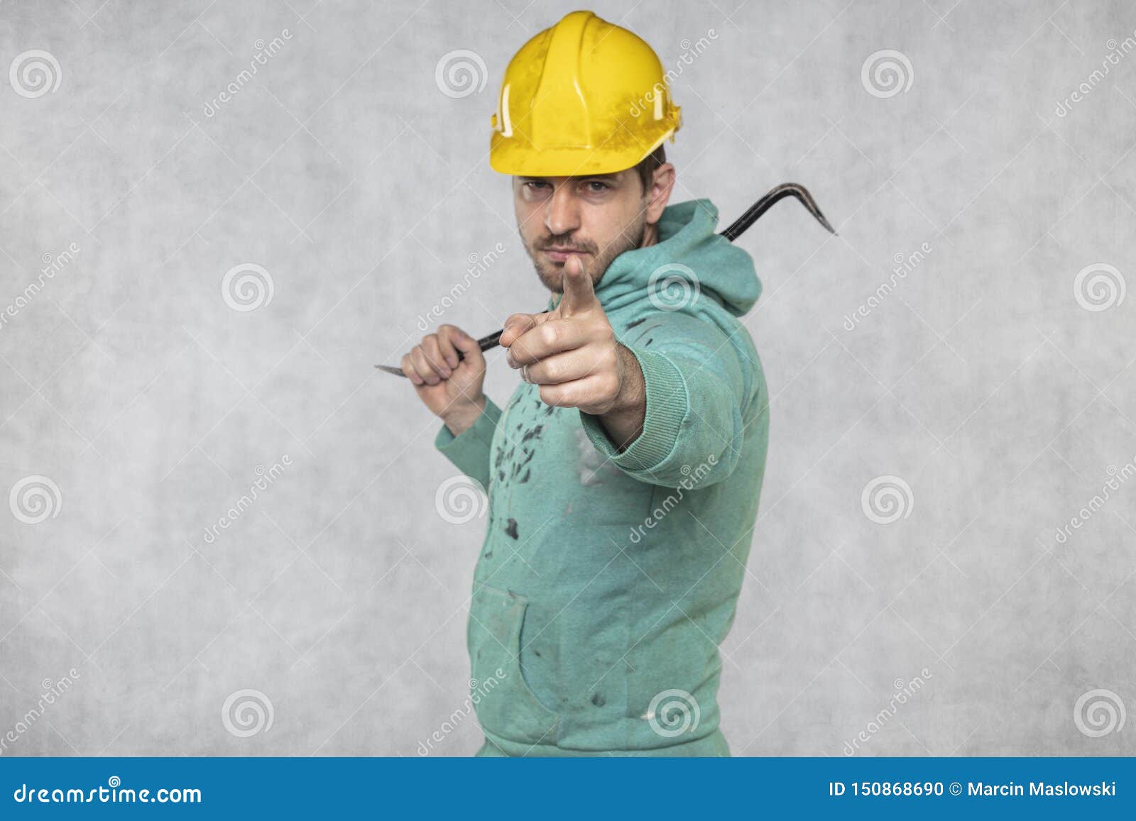The Construction Worker Holds a Work Tool in His Hands, a Crowbar Stock ...