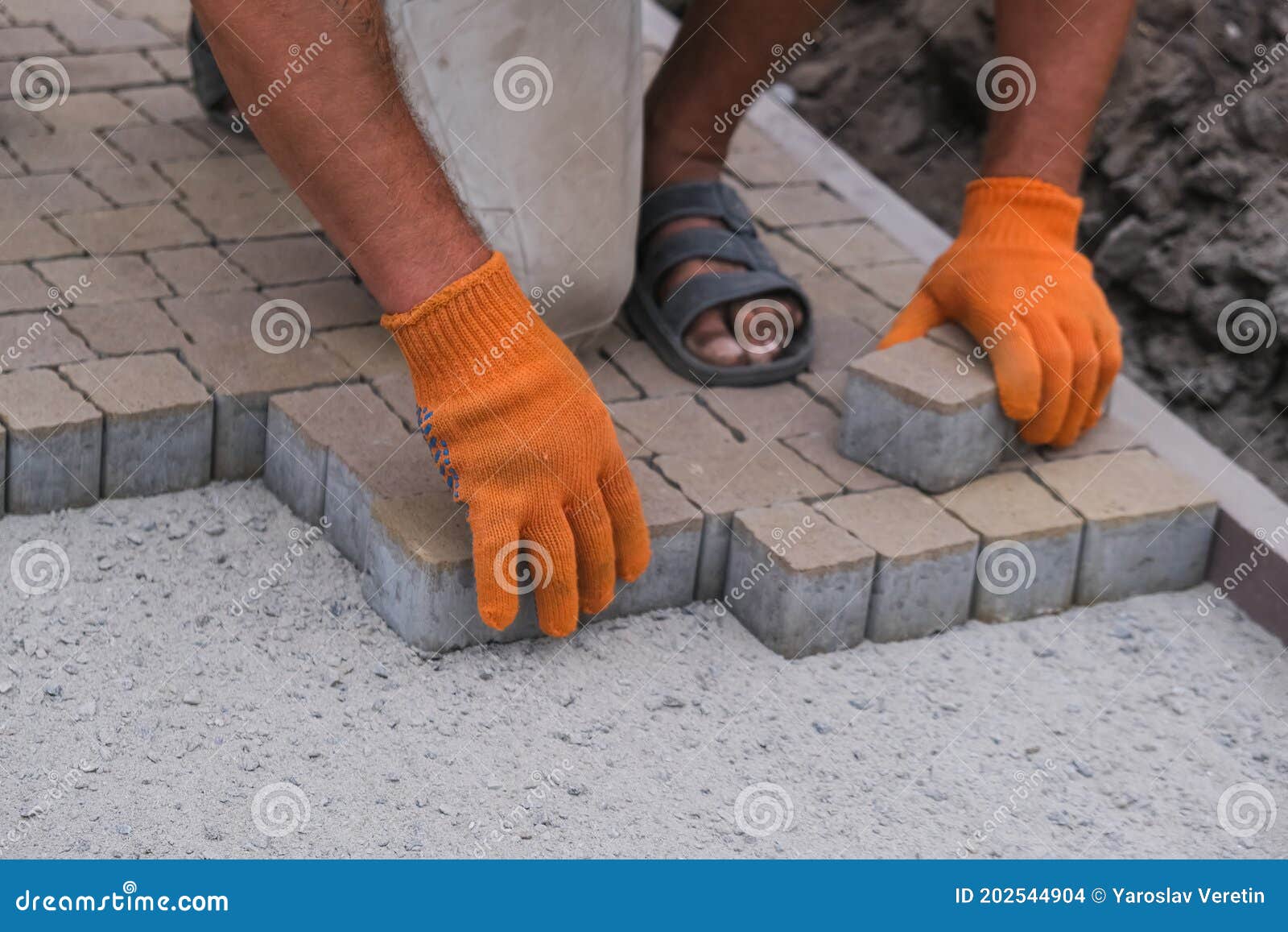 Construction Worker Installing and Laying Pavement Stones on Terrace ...