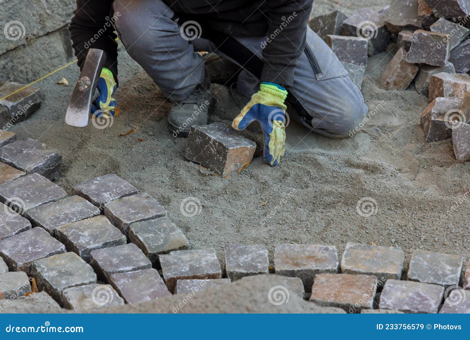 Construction Worker Installing Stone on Road is Putting Down Pavers ...