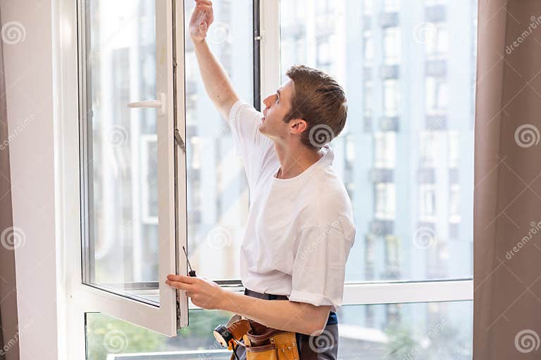 Construction Worker Installing Window in House. Stock Image - Image of ...