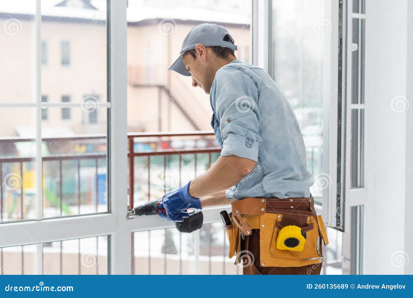 Construction Worker Installing Window in House. Handyman Fixing the ...