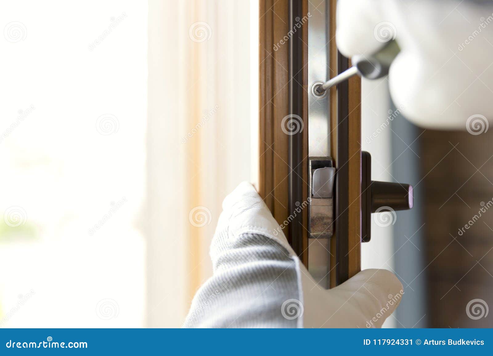 Construction Worker Installing Window in House. Handyman Fixing the ... Construction Worker Installing Window in House. Handyman Fixing the ...