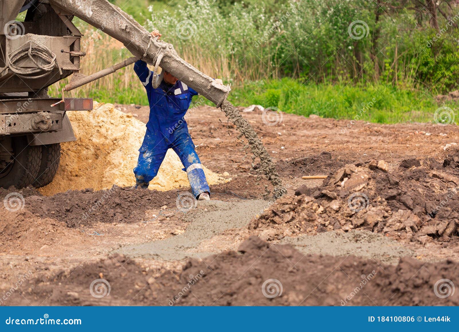 Construction Worker Laying Cement or Concrete into the Foundation ...