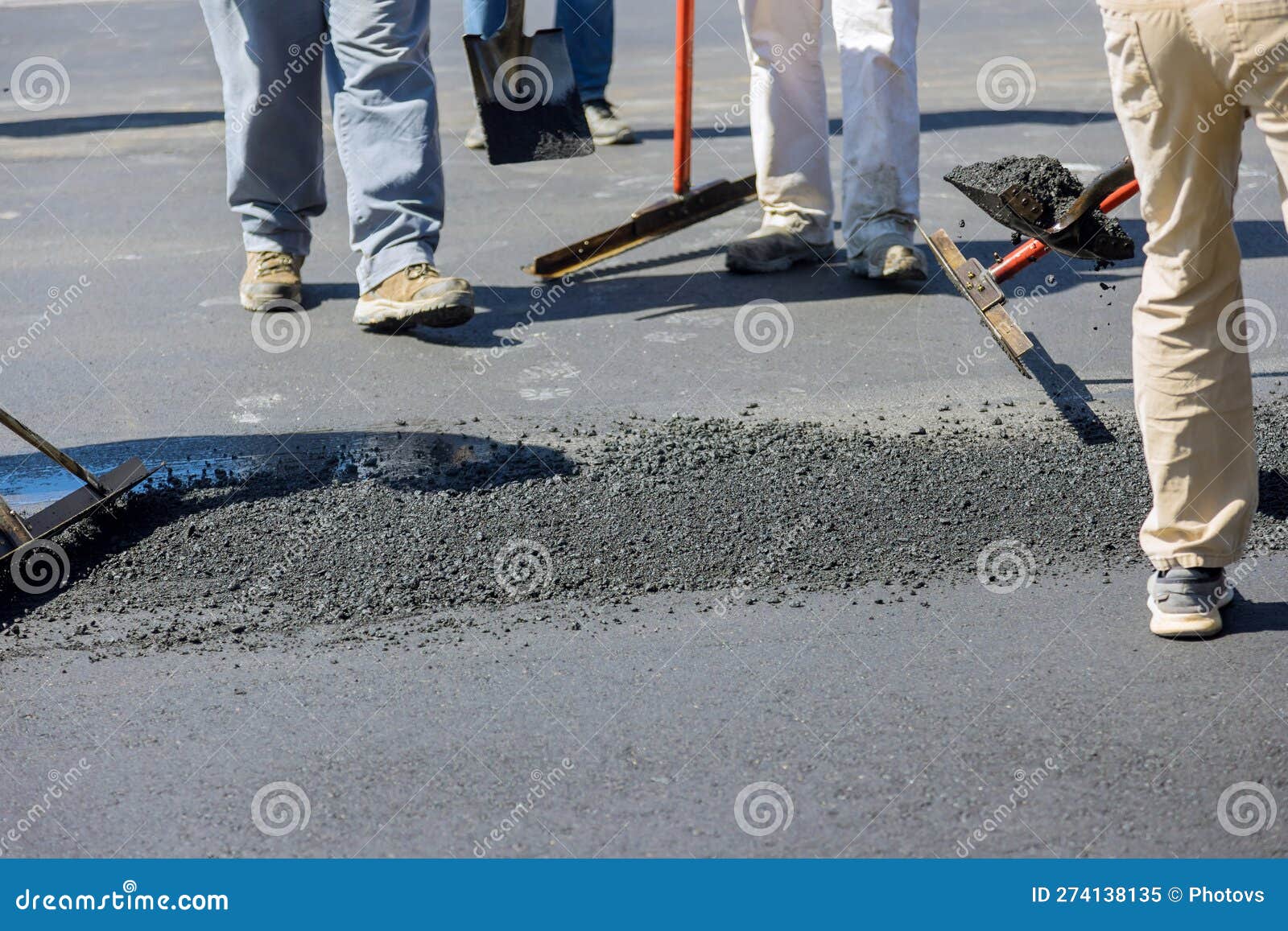 Construction Worker Laying New Asphalt Roads As Part of a Process of ...