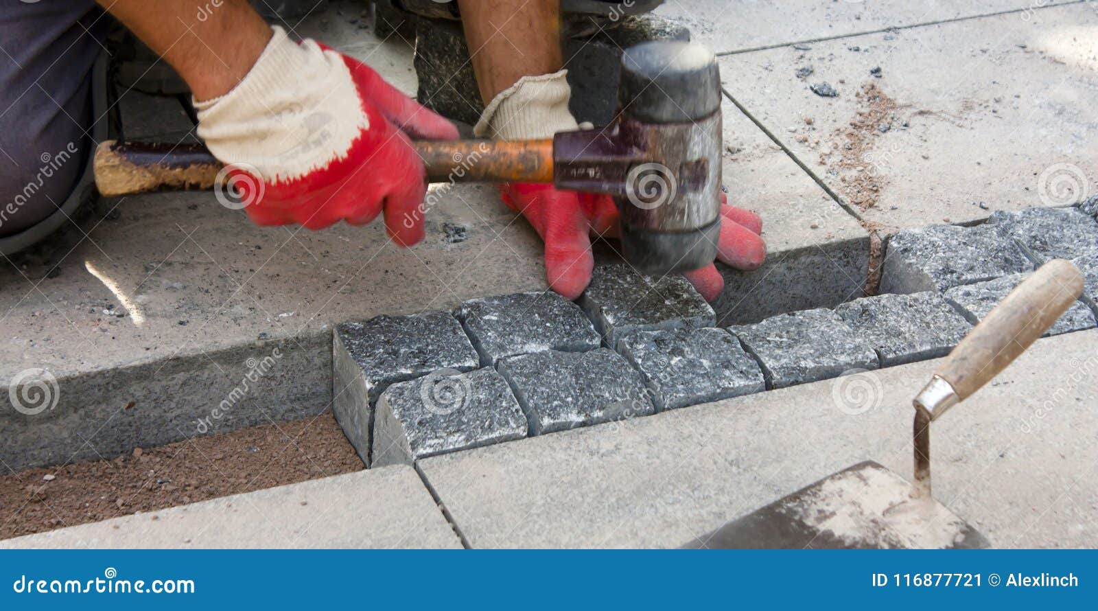 Construction Worker Laying Stone Cobbles in Sand Stock Image - Image of ...