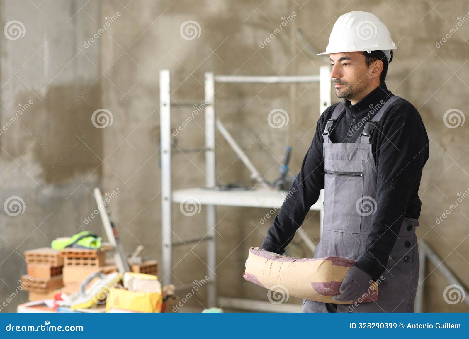 Construction Worker Lifting a Concrete Bag Stock Image - Image of ...