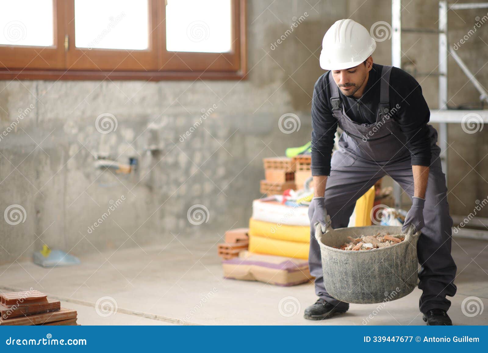 Construction Worker Lifting a Heavy Carrycot Stock Image - Image of ...