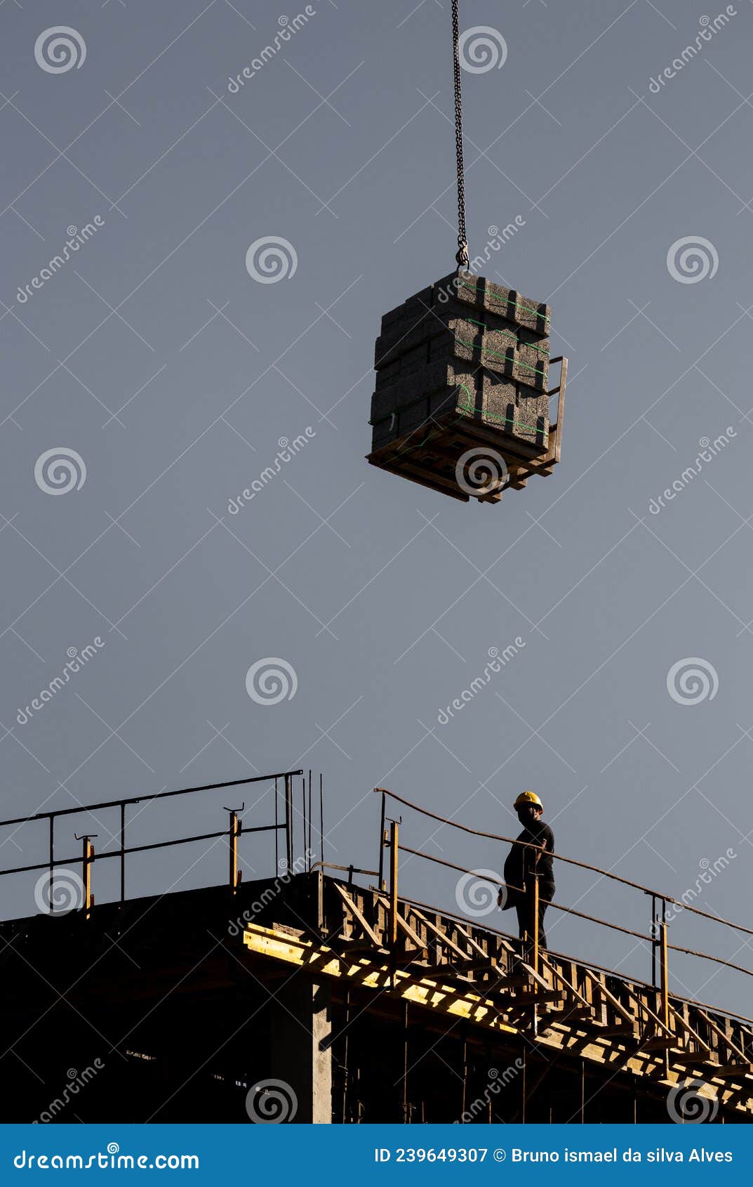 A Construction Worker, Loading a Construction Crane in a Construction ...