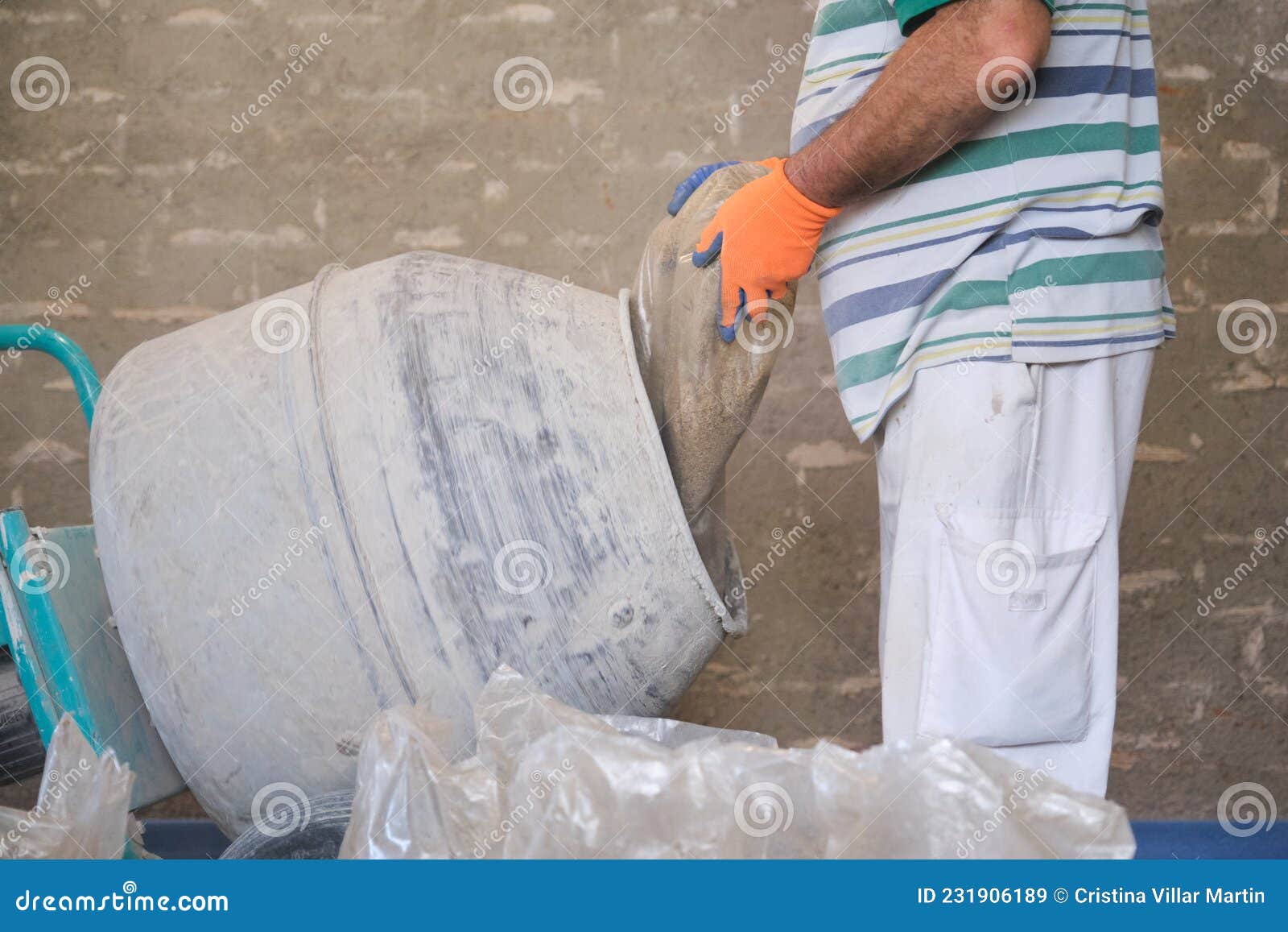 Construction Worker Loading a Sandbag into the Concrete Mixer. Stock ...