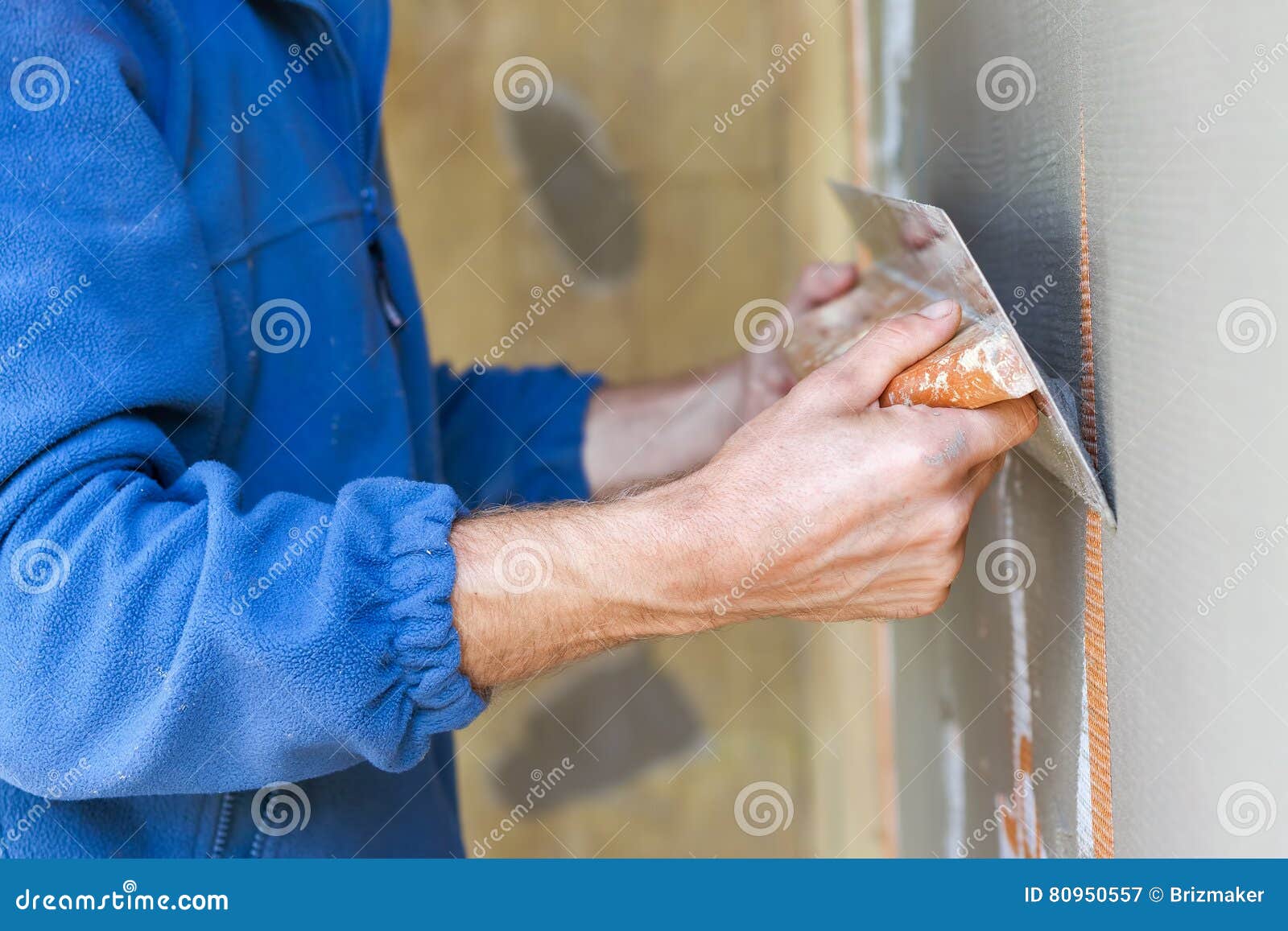 Construction Worker with Long Trowel Plastering a Wall. Stock Image ...