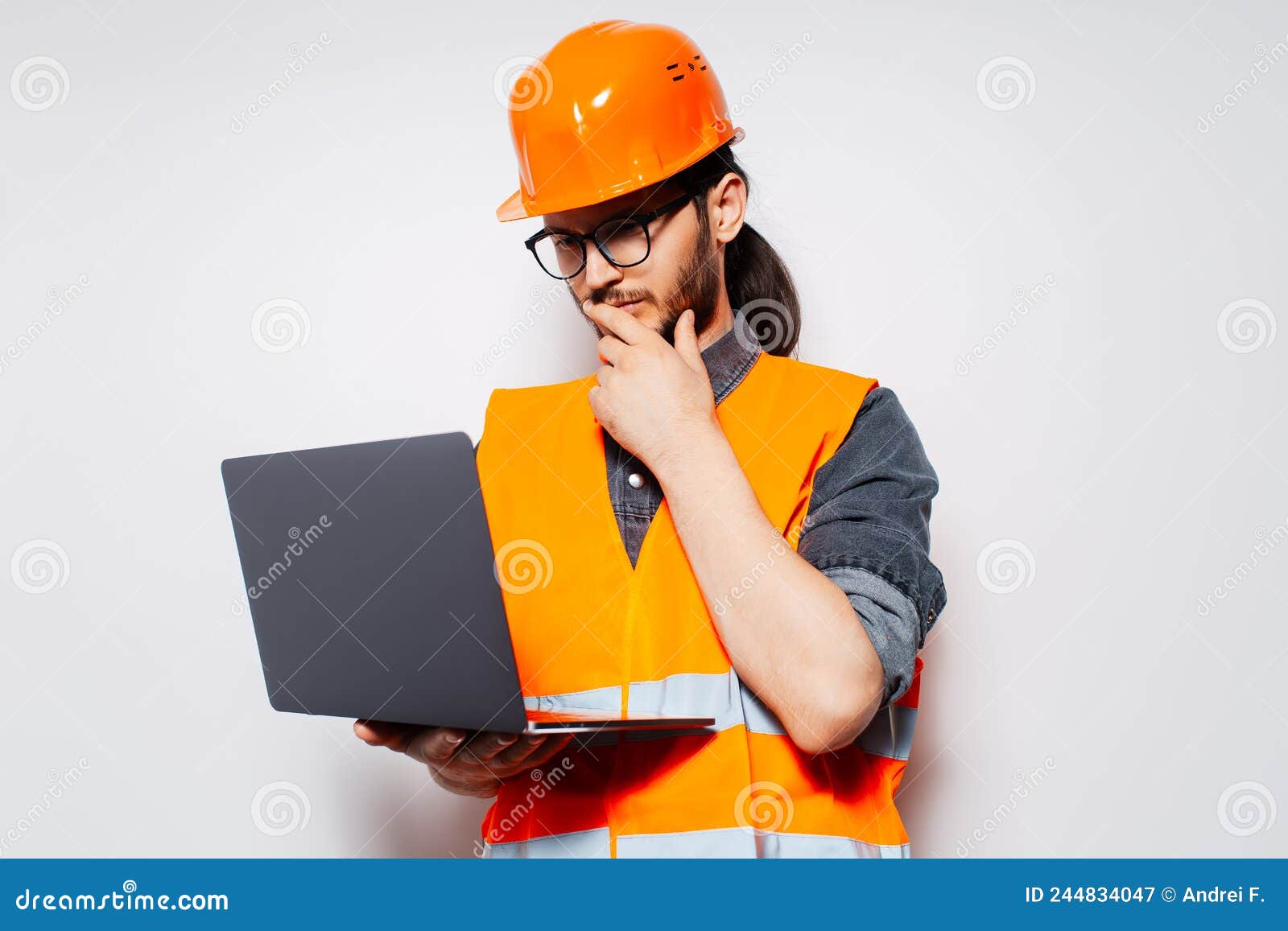 Construction Worker Looking in Laptop on White Background. Orange ...