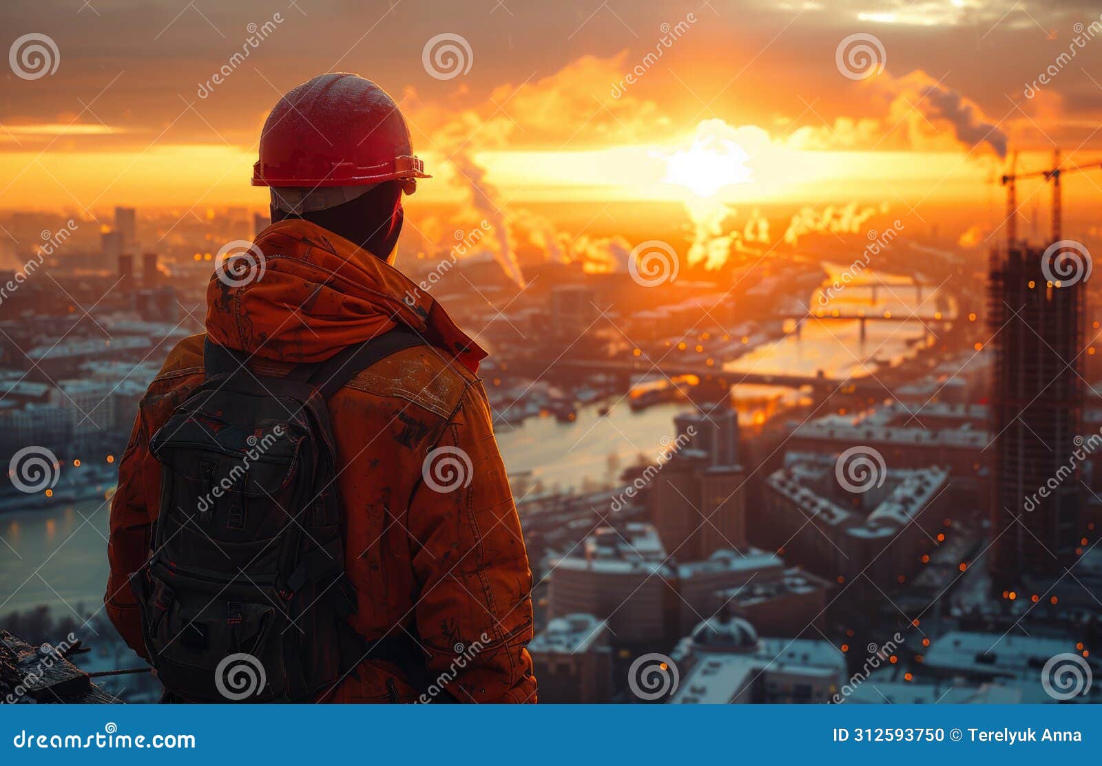 Construction Worker Looking at the Sunrise Over the City. Industrial ...