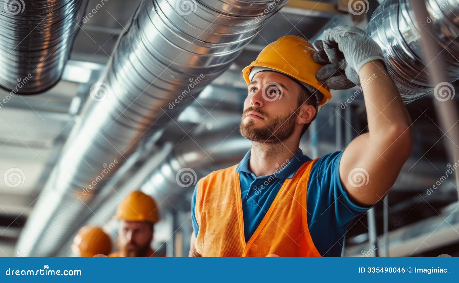 Construction Worker Looking Up at Large Ventilation Ducts Stock ...