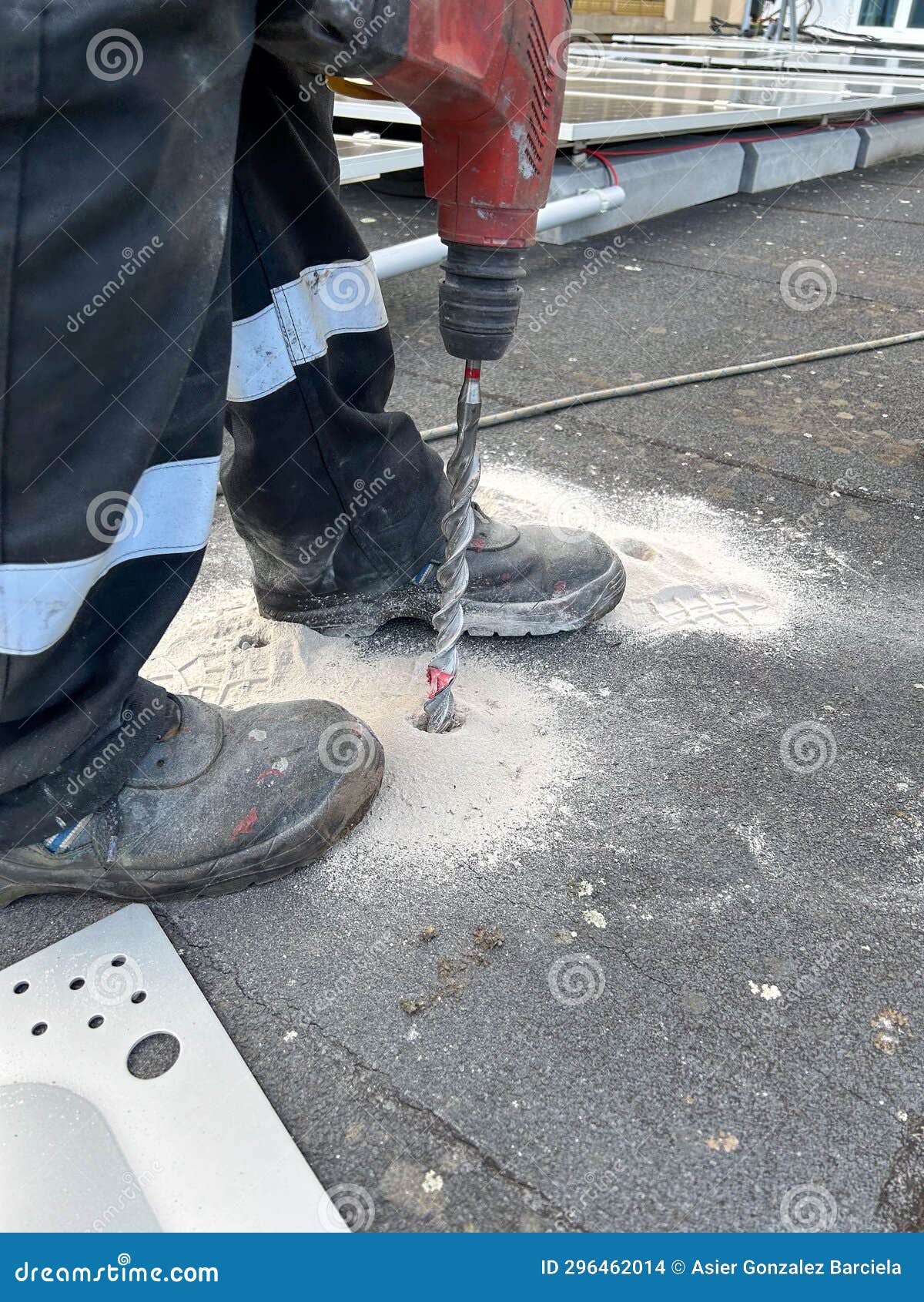 Construction Worker Making a Hole in the Concrete Floor with a Drill ...