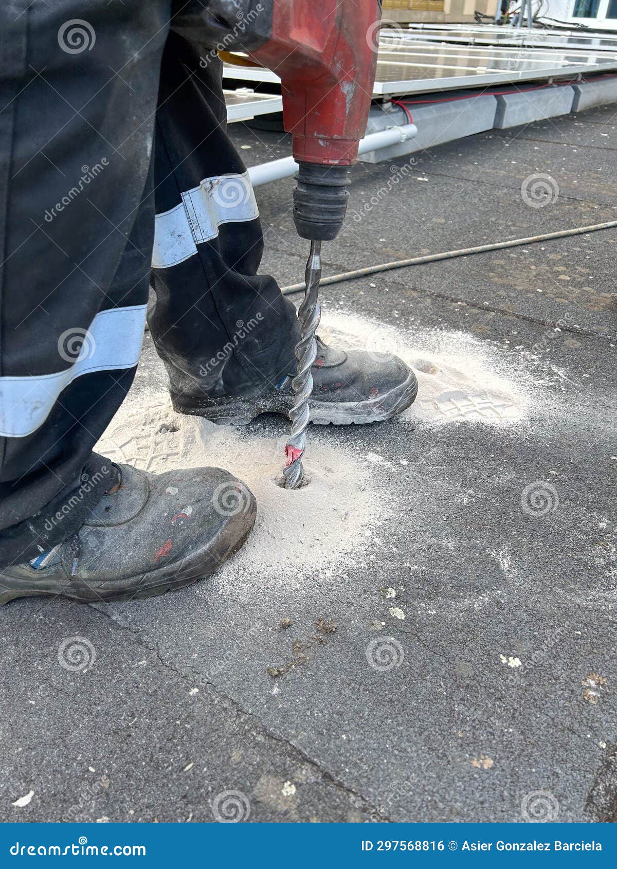 Construction Worker Making a Hole in the Concrete Floor with a Drill ...