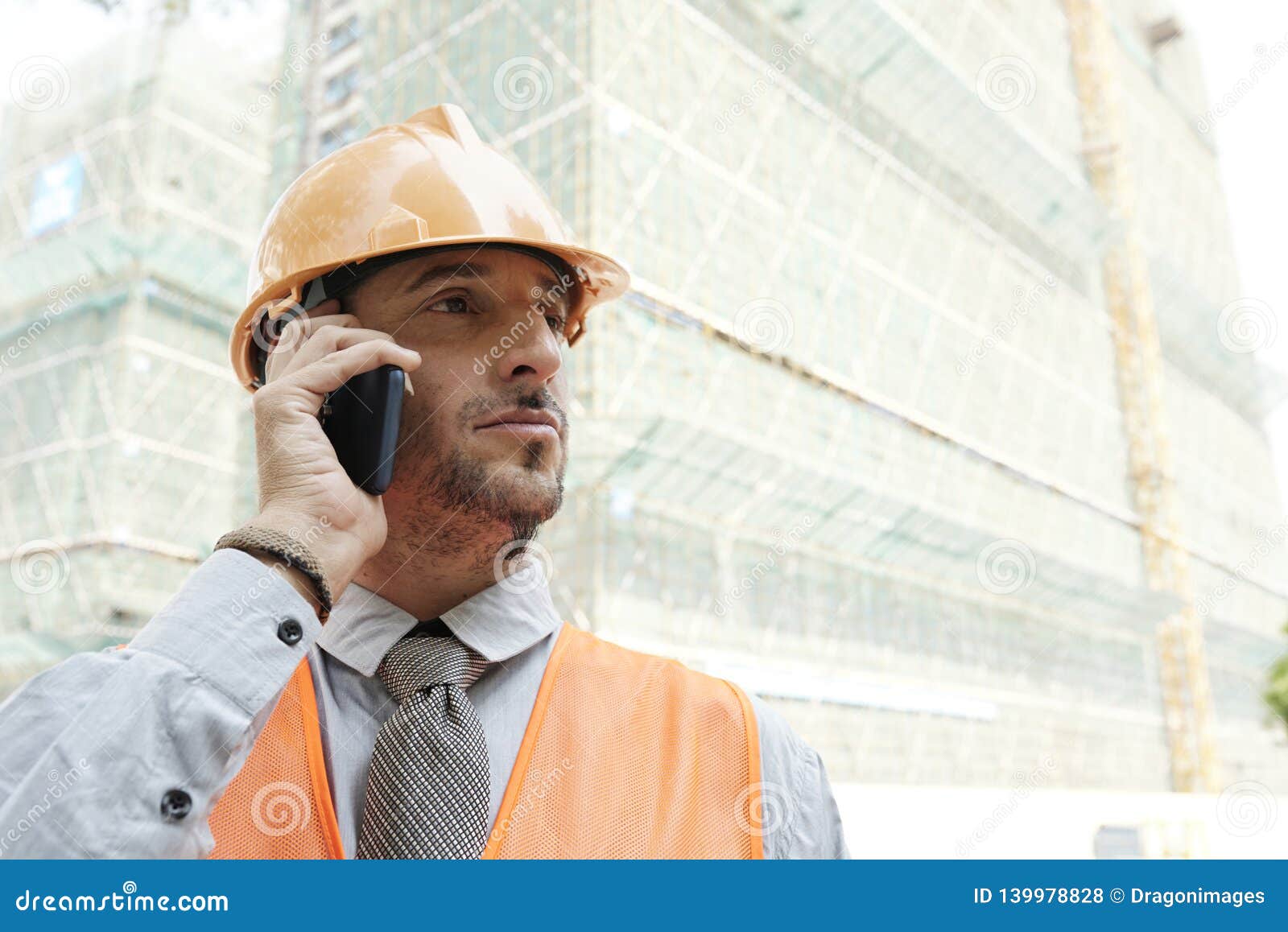 Construction Worker Making Phone Call Stock Photo - Image of plan ...