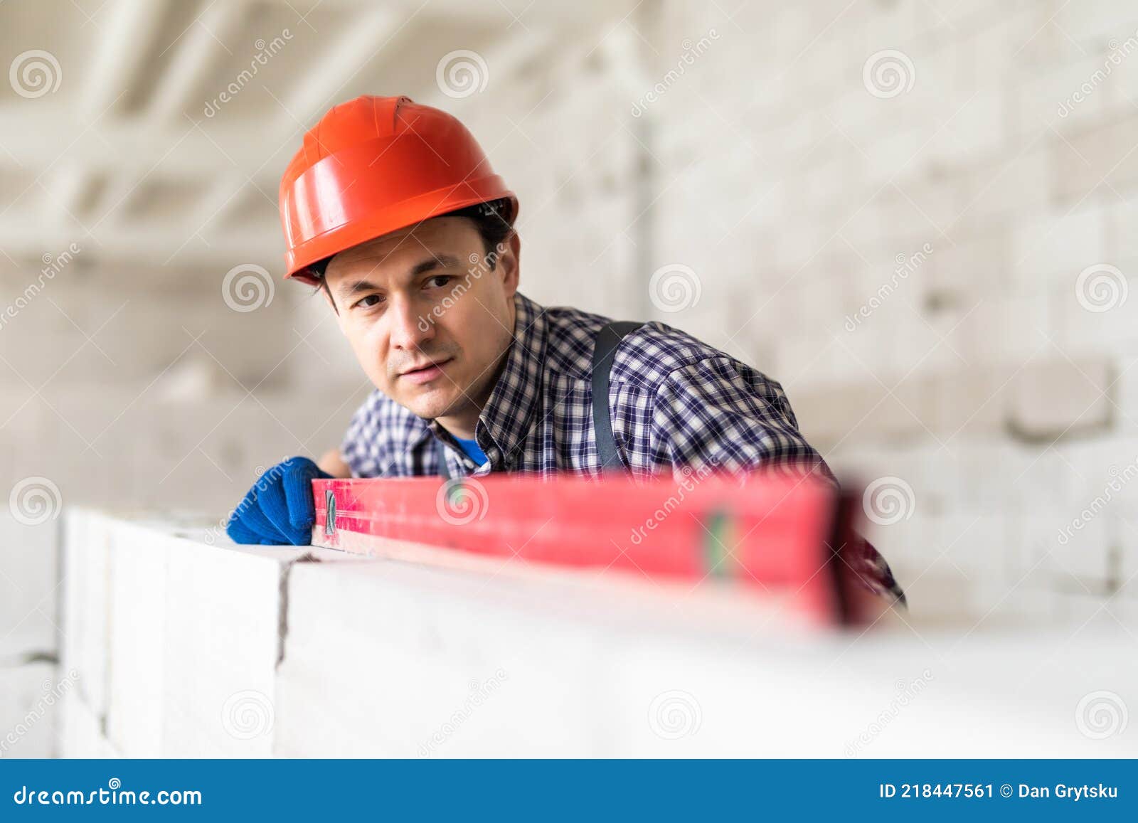 Construction Worker Man Observing and Surveying Wall Alignment Using ...