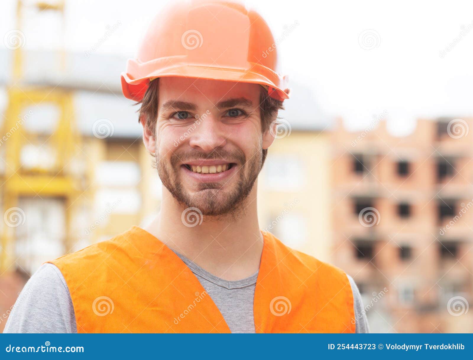 Construction Worker Man in Work Clothes and a Construction Helmet ...