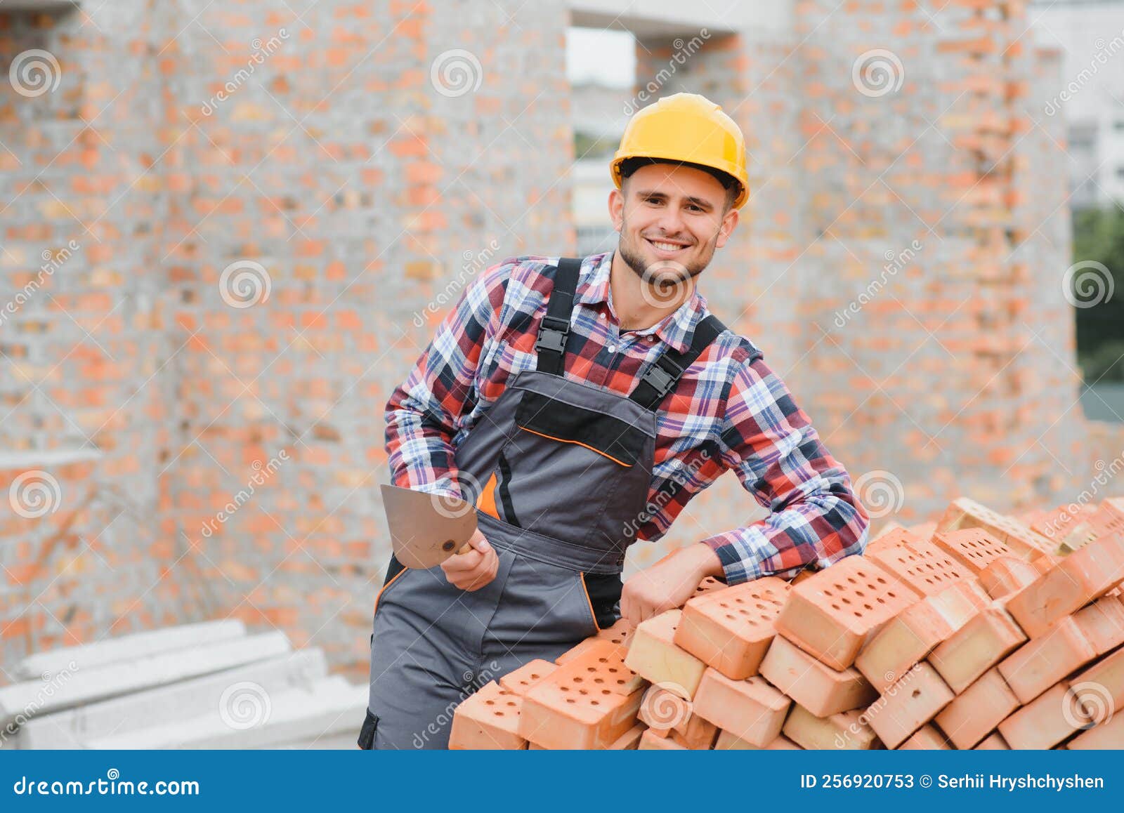Construction Worker Man in Work Clothes and a Construction Helmet ...