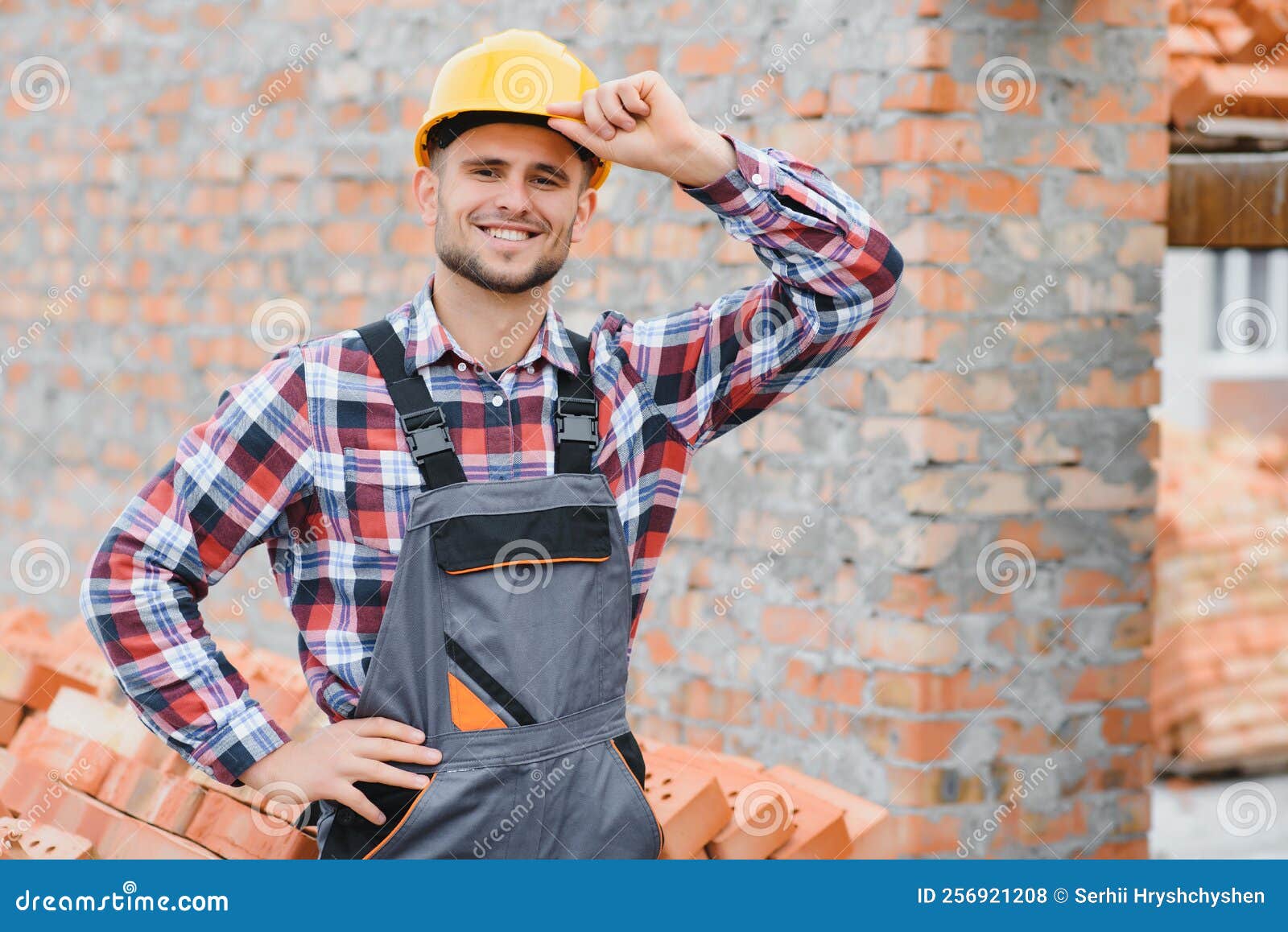Construction Worker Man in Work Clothes and a Construction Helmet ...