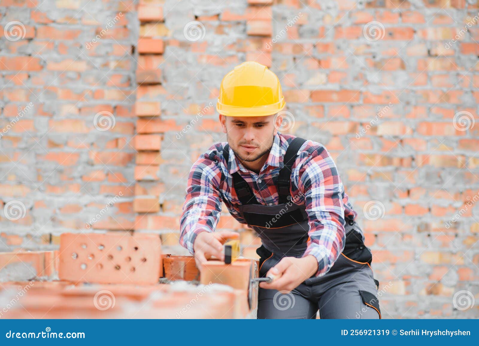 Construction Worker Man in Work Clothes and a Construction Helmet ...