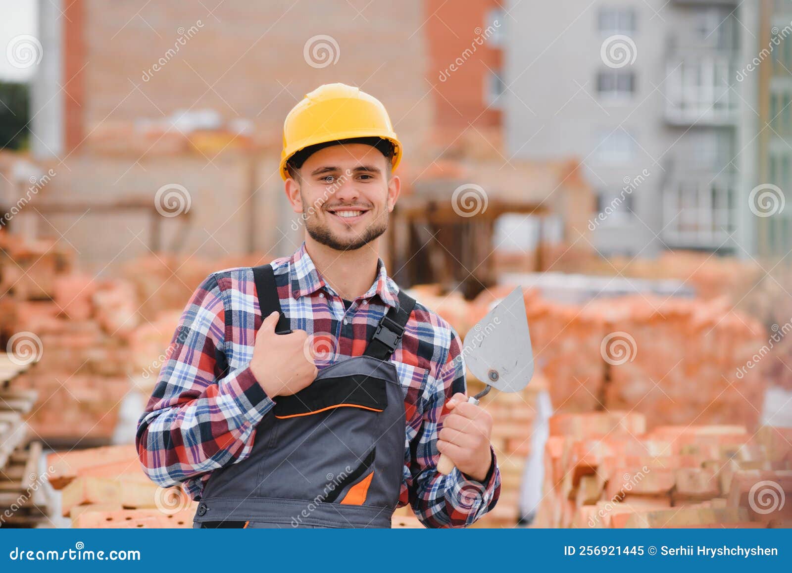 Construction Worker Man in Work Clothes and a Construction Helmet ...