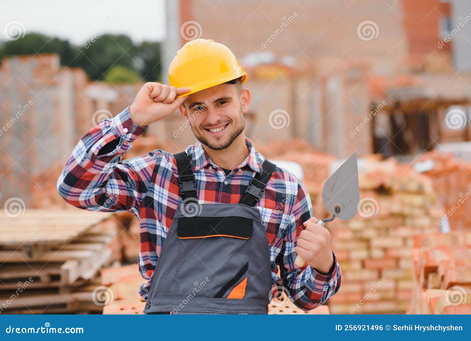 Construction Worker Man in Work Clothes and a Construction Helmet ...