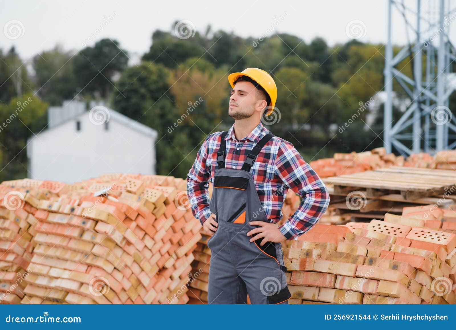 Construction Worker Man in Work Clothes and a Construction Helmet ...