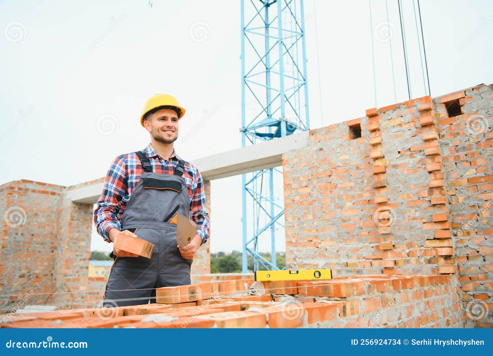 Construction Worker Man in Work Clothes and a Construction Helmet ...