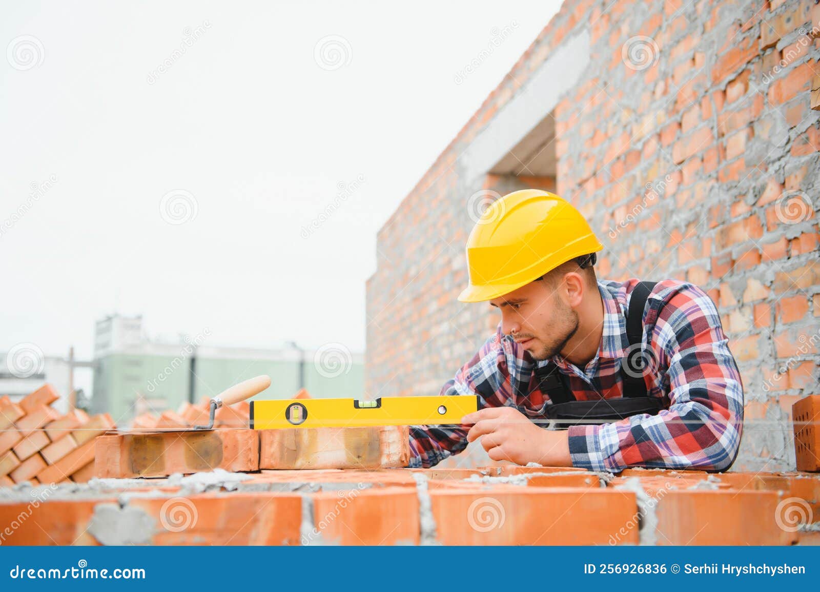 Construction Worker Man in Work Clothes and a Construction Helmet ...