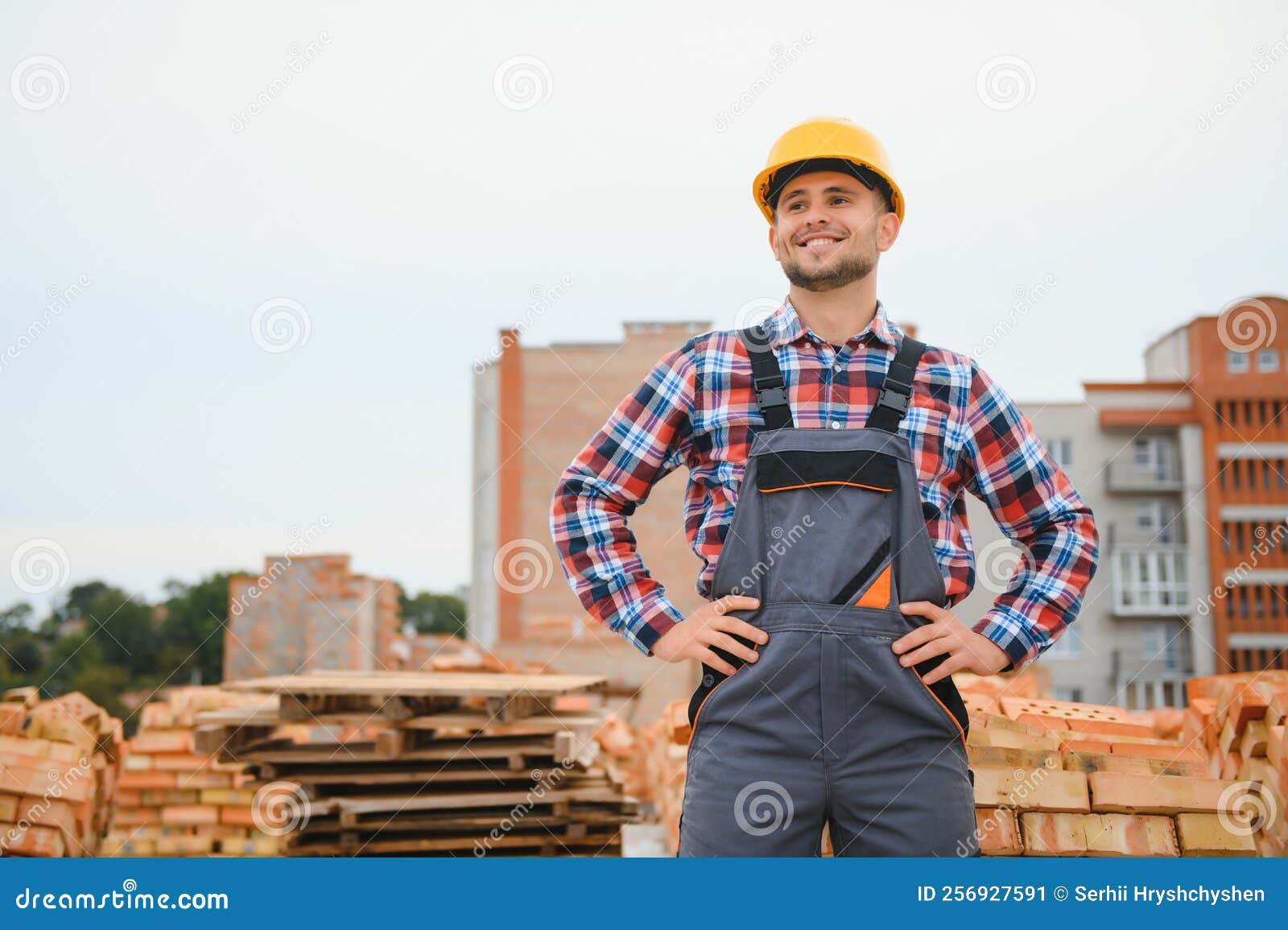 Construction Worker Man in Work Clothes and a Construction Helmet ...