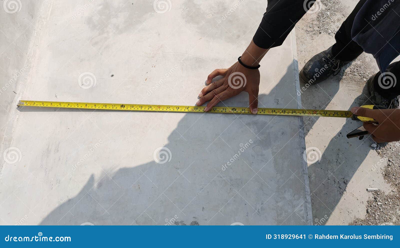 Construction Worker Measuring Concrete Surface with Tape Measure Stock ...