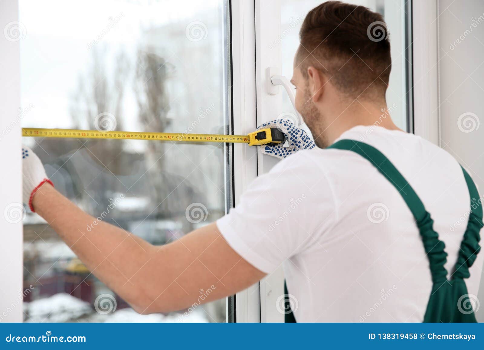 Construction Worker Measuring Plastic Window. Professional Installation ...