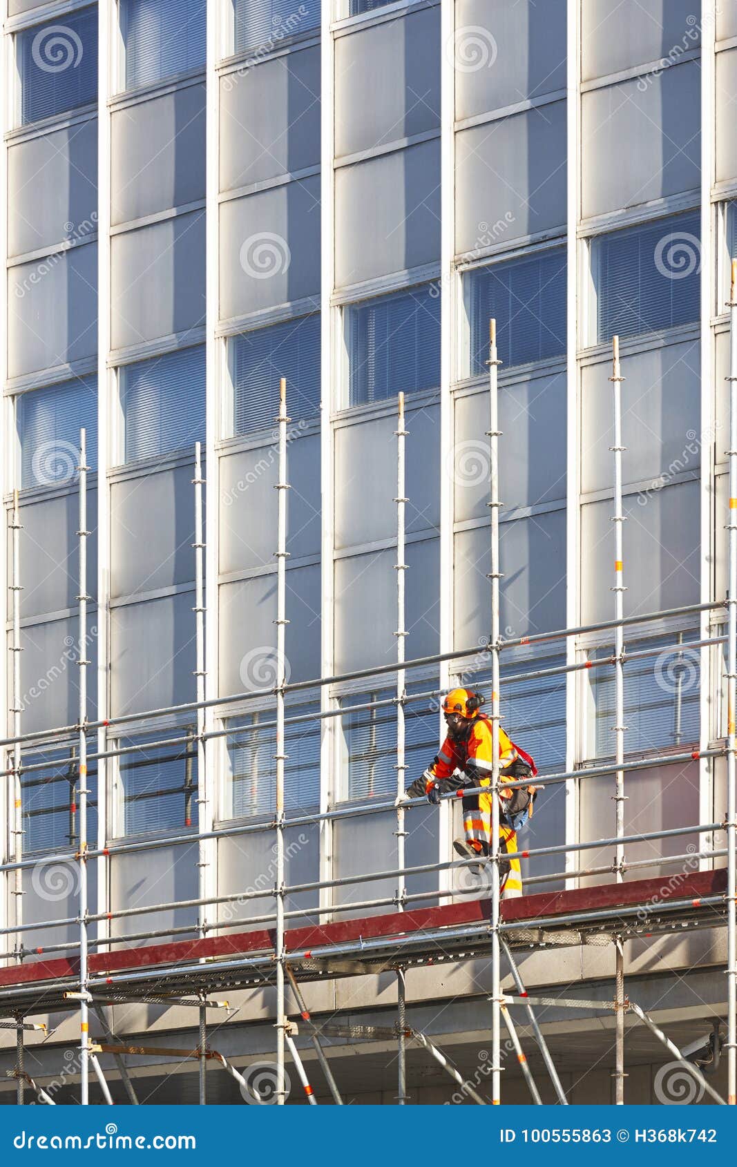 Construction Worker Mounting A Scaffolding Structure On A Building ...