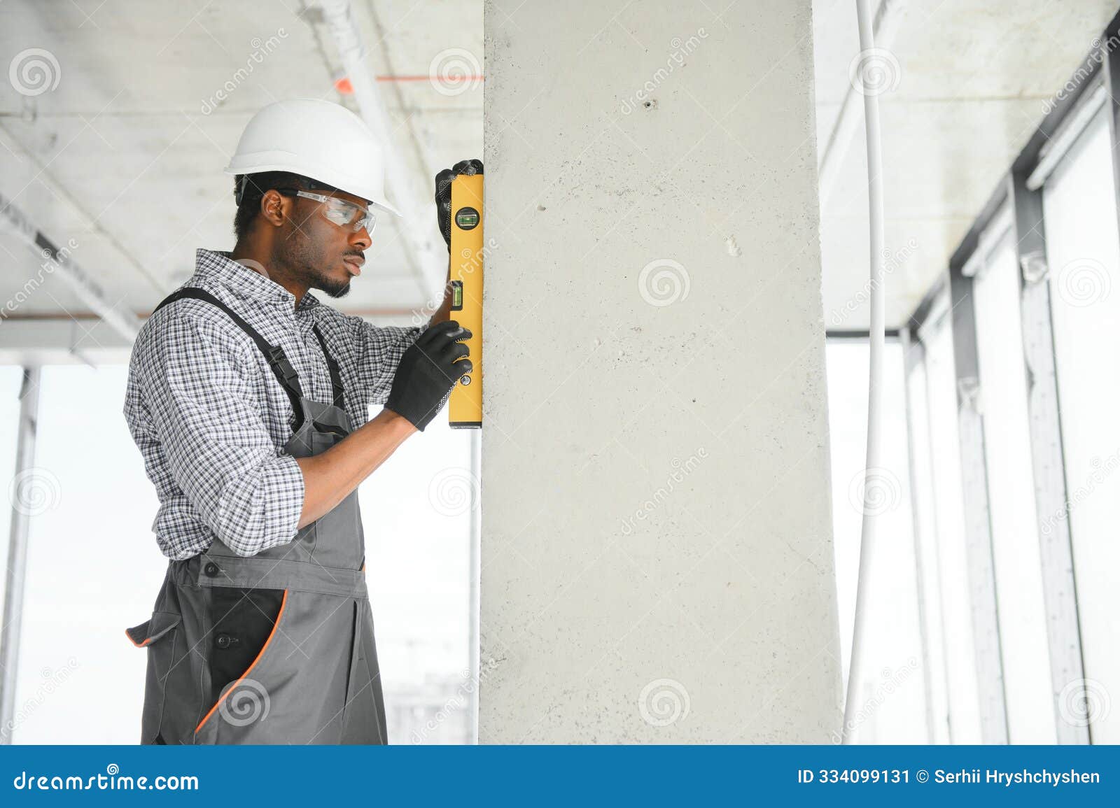 Construction Worker Observing and Surveying Wall Alignment Using Water ...