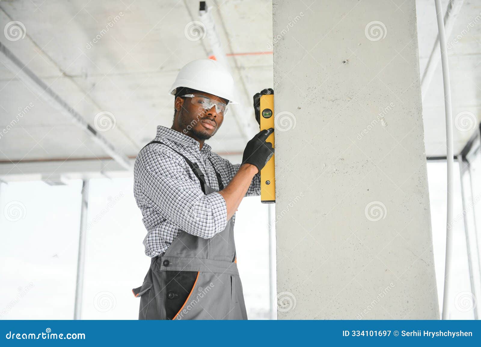 Construction Worker Observing and Surveying Wall Alignment Using Water ...