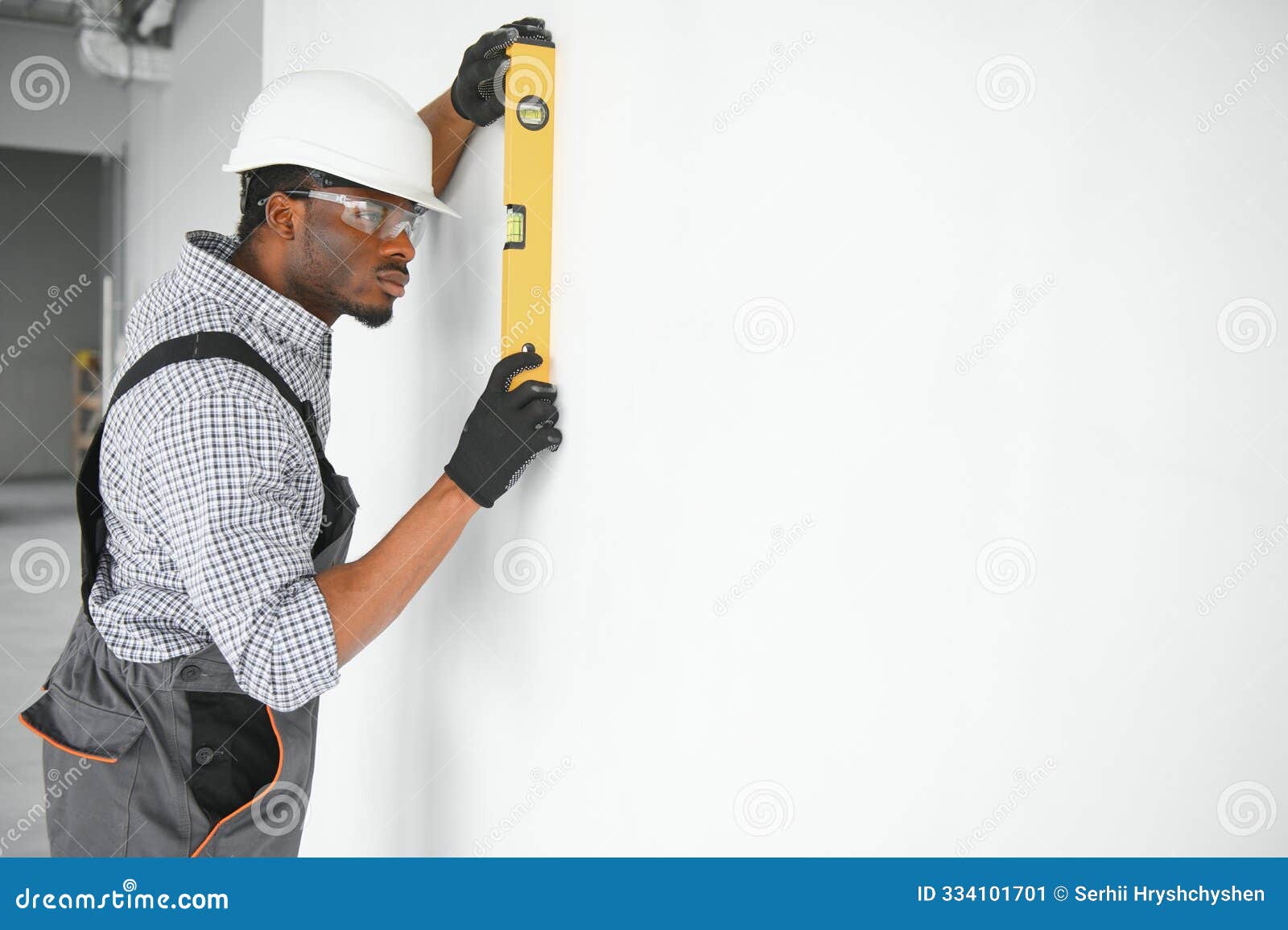 Construction Worker Observing and Surveying Wall Alignment Using Water ...