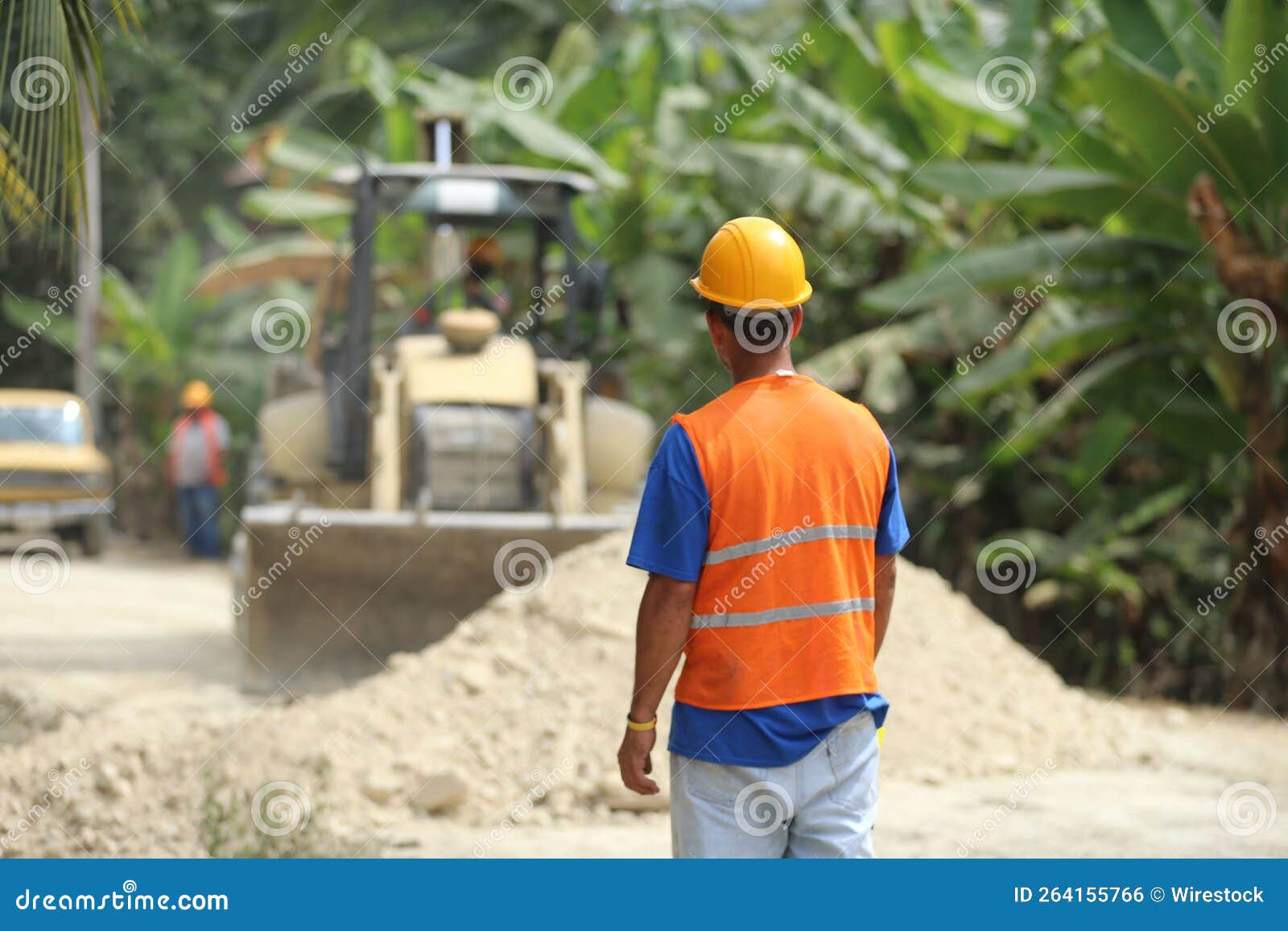 Construction Worker in an Orange Jacket and Helmet on the Background of ...