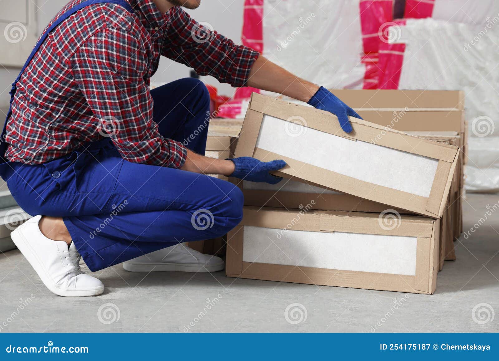 Construction Worker with Packed New Boxes in Room Prepared for ...