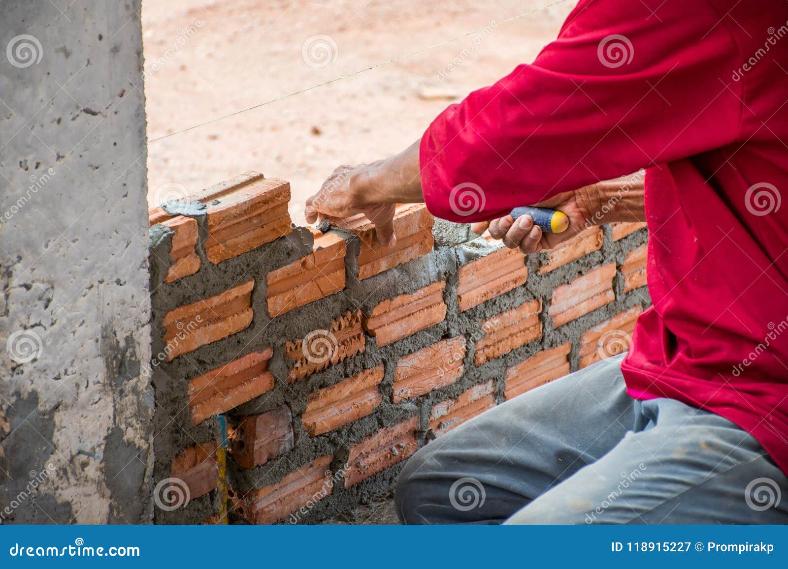 Construction Worker Placing Bricks on Cement for Building Stock Image ...