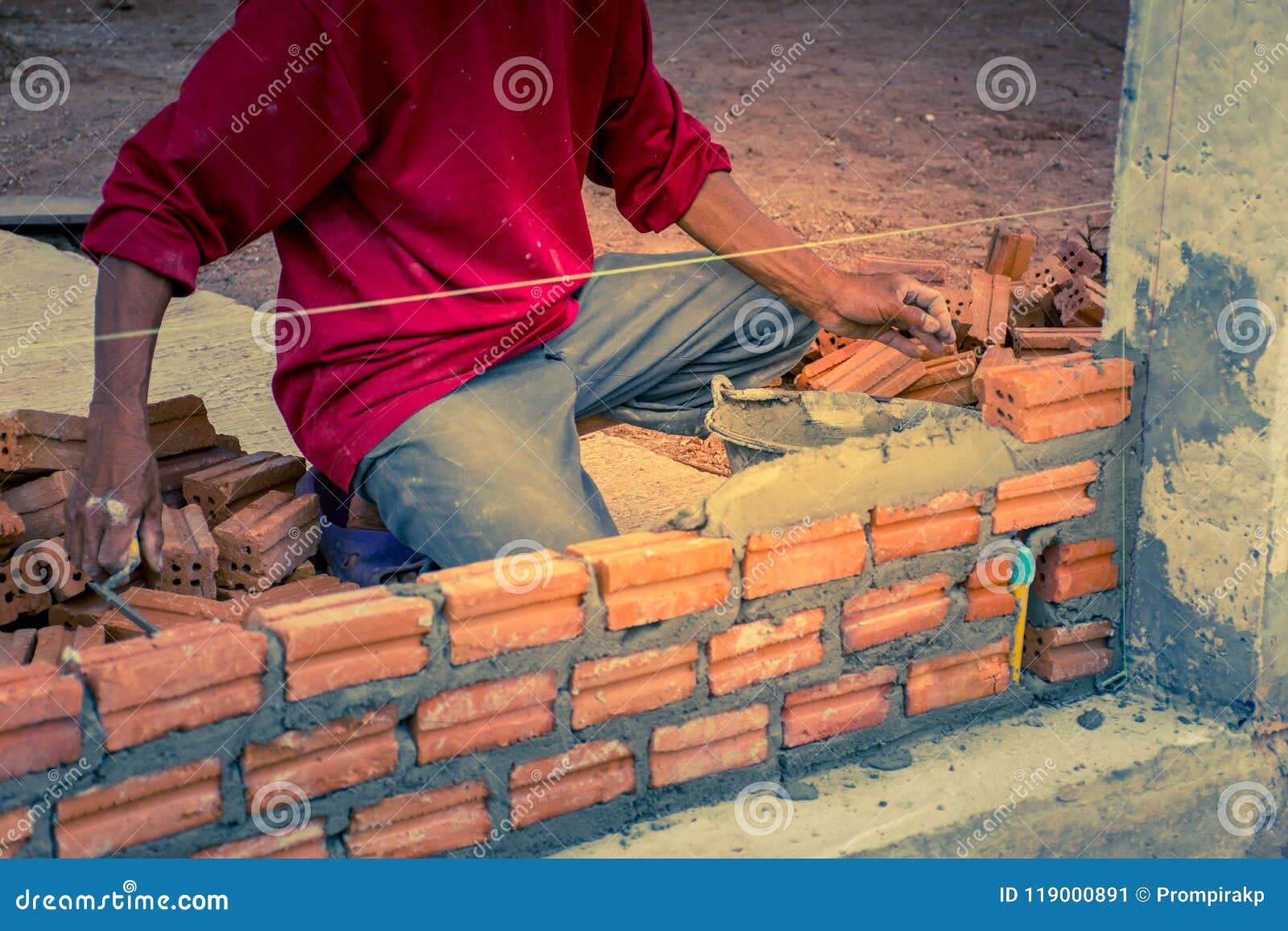 Construction Worker Placing Bricks on Cement for Building Exterior ...