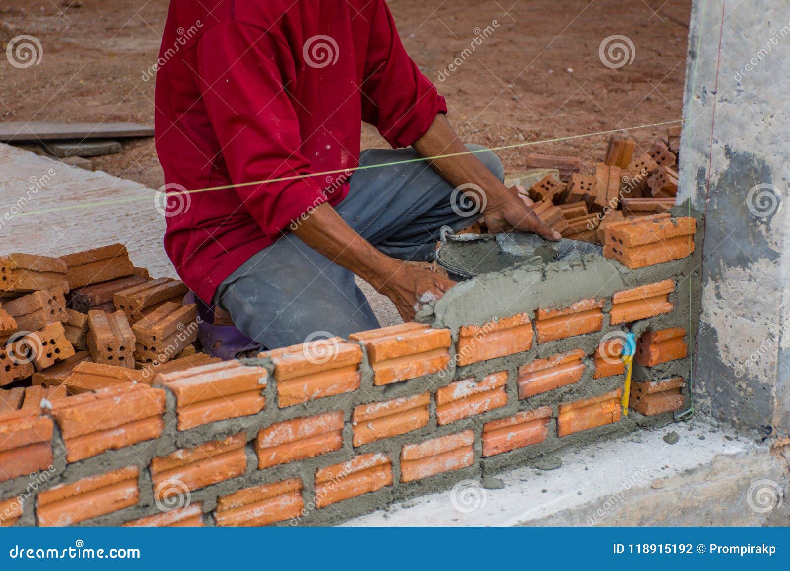 Construction Worker Placing Bricks on Cement for Building Stock Photo ...