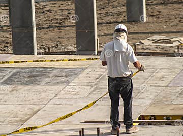 Construction Worker Placing Caution Tape at a Construction Site Stock ...