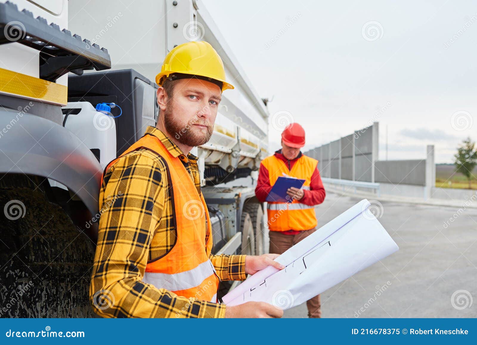 Construction Worker with Plan on Construction Site of Road Construction ...